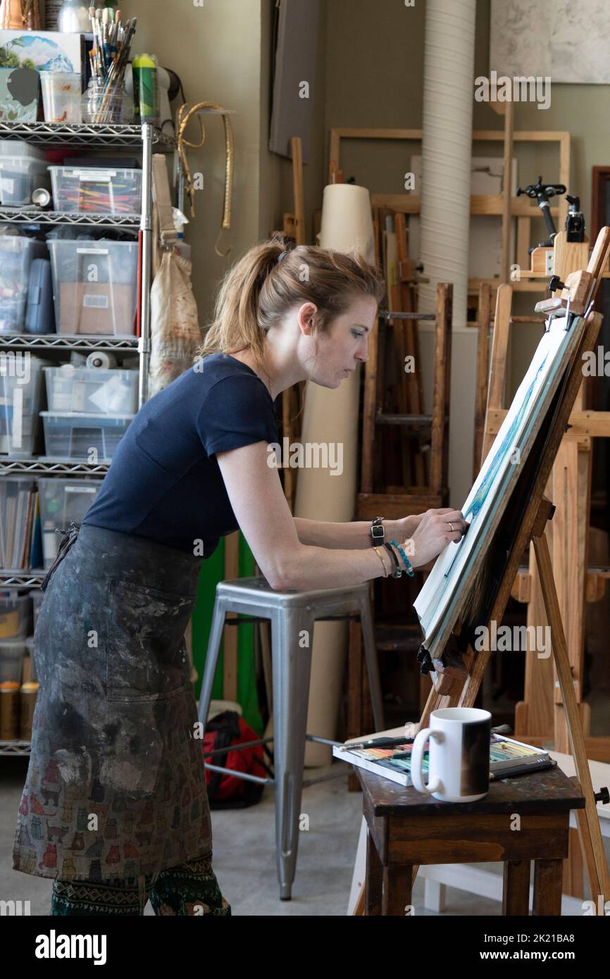 Female artist drawing at easel in art studio Stock Photo - Alamy