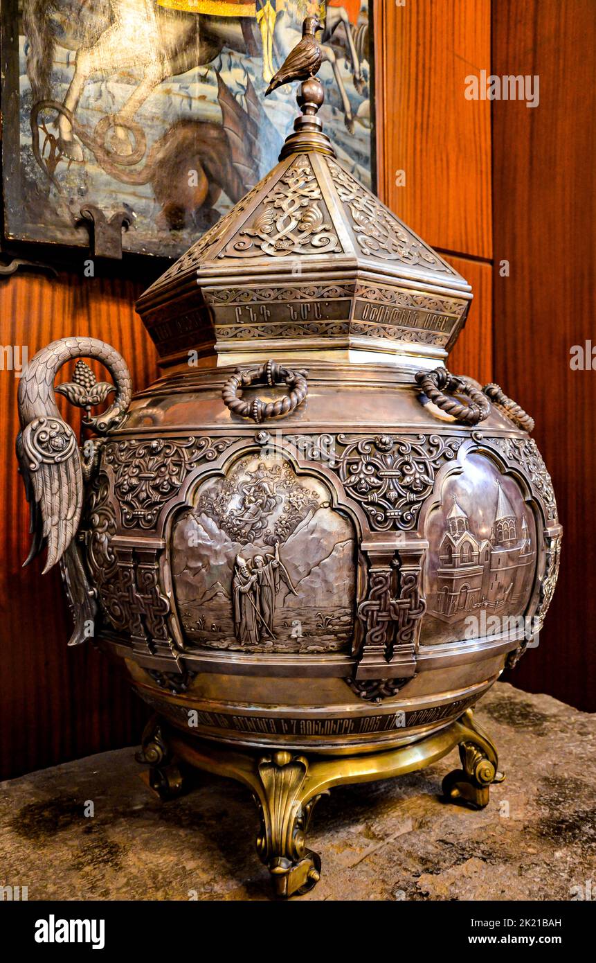 A vertical shot of an ancient metal holly water urn in Yerevan, Armenia ...