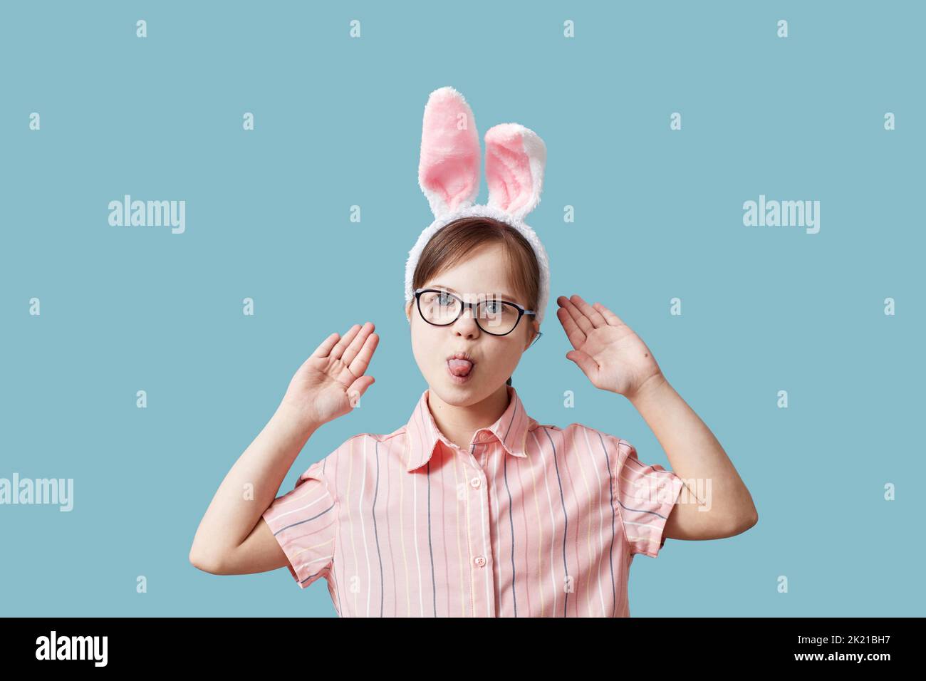 Portrait of teen girl with Down syndrome wearing Easter bunny ears ...