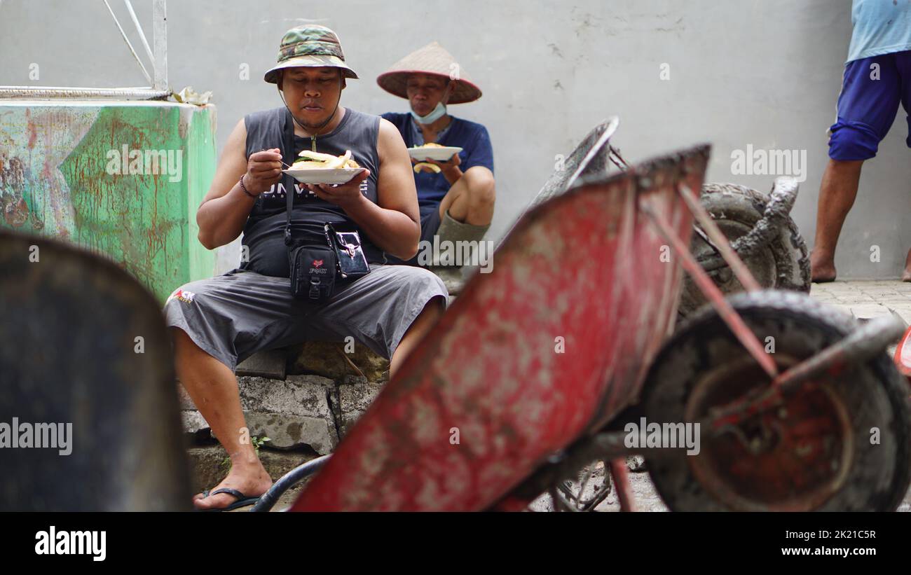 A closeup of people eating together after they have finished working ...