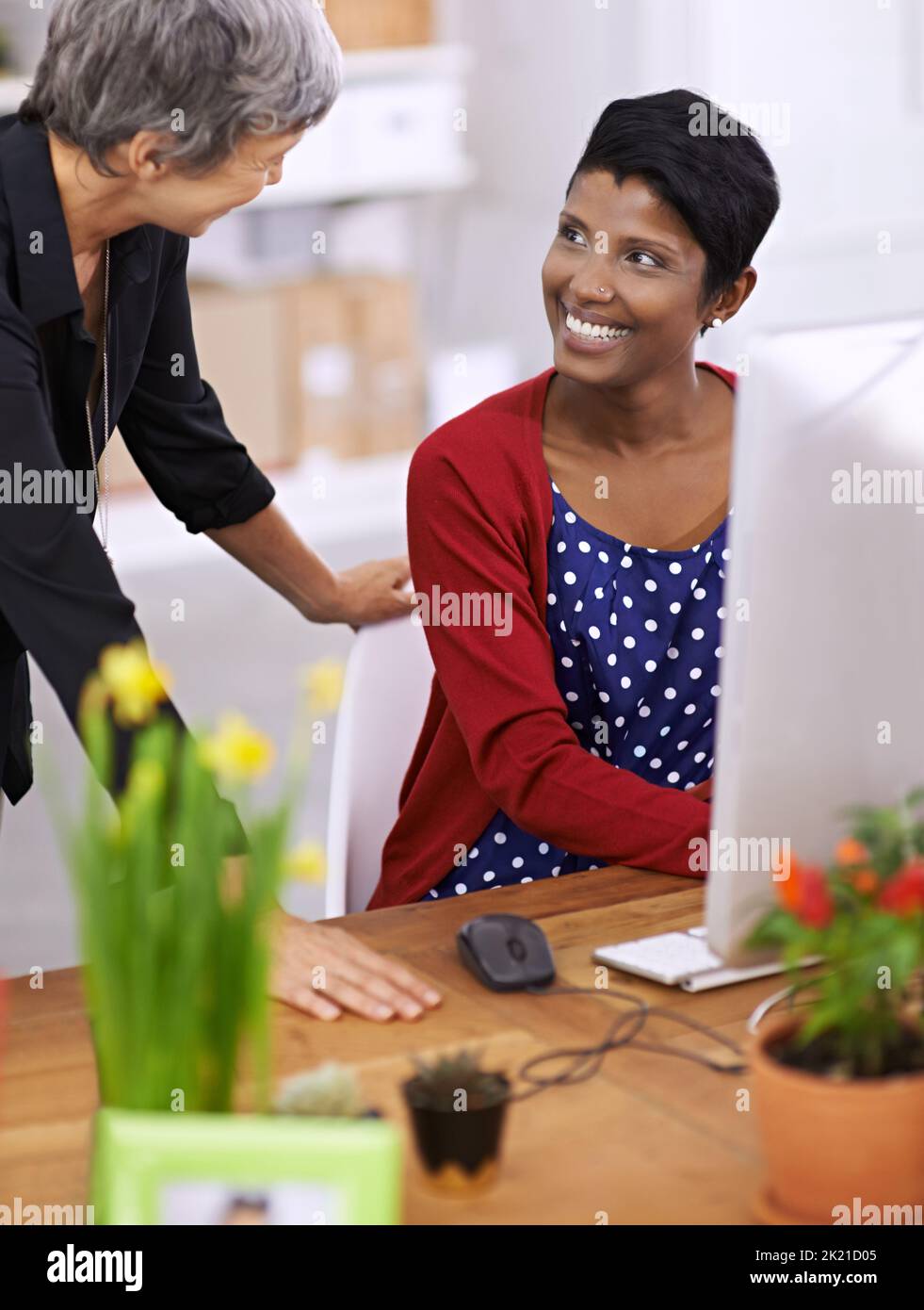 Colleagues and friends. two female colleagues having a friendly work ...