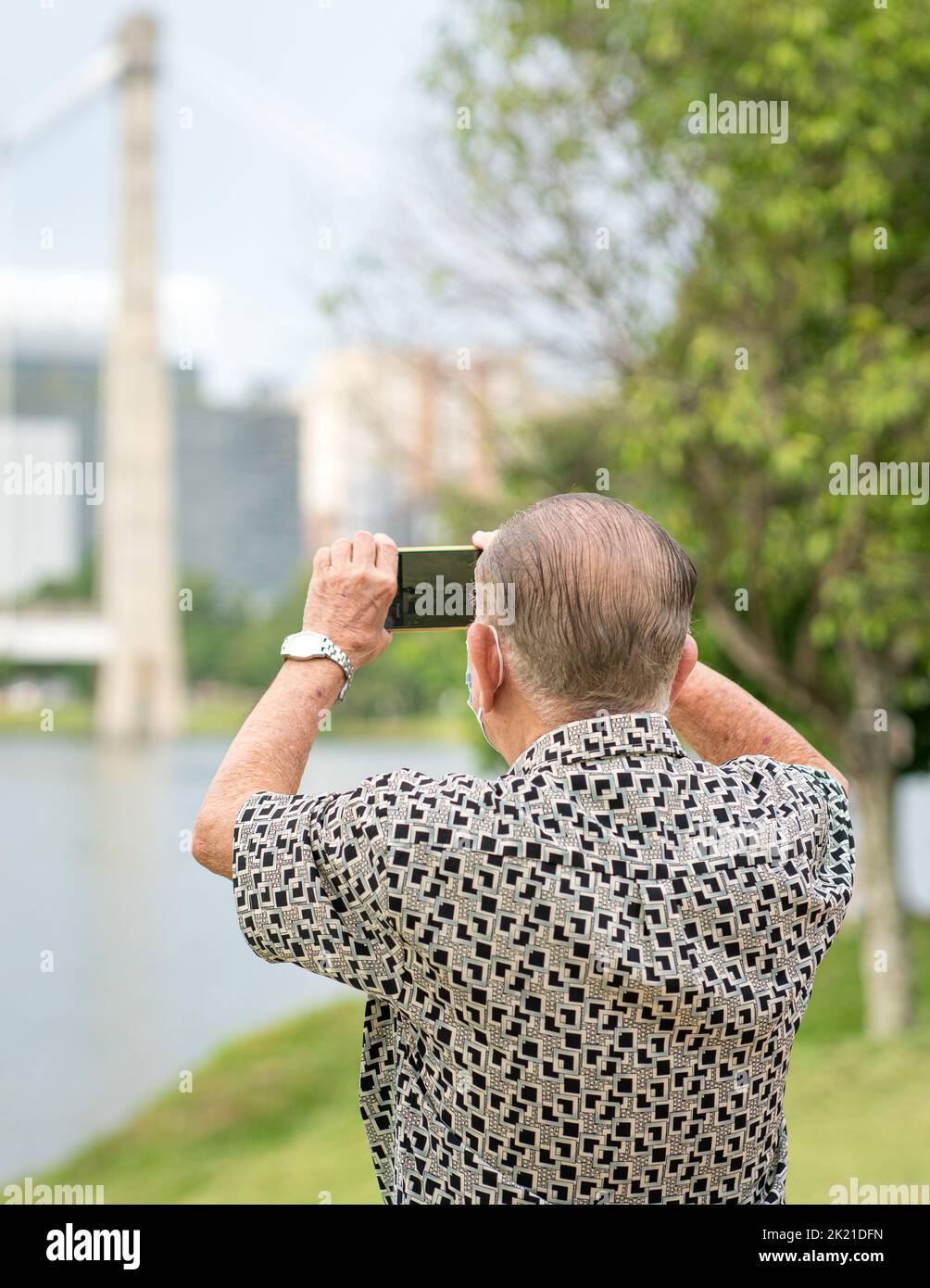 Senior man using smartphone to take photos and video. Travel and ...