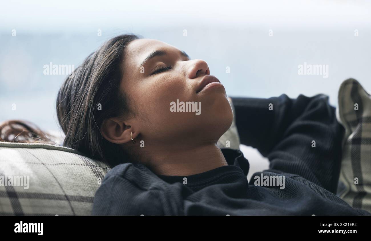 Relax, tired and rest with woman on sofa in living room for stress ...