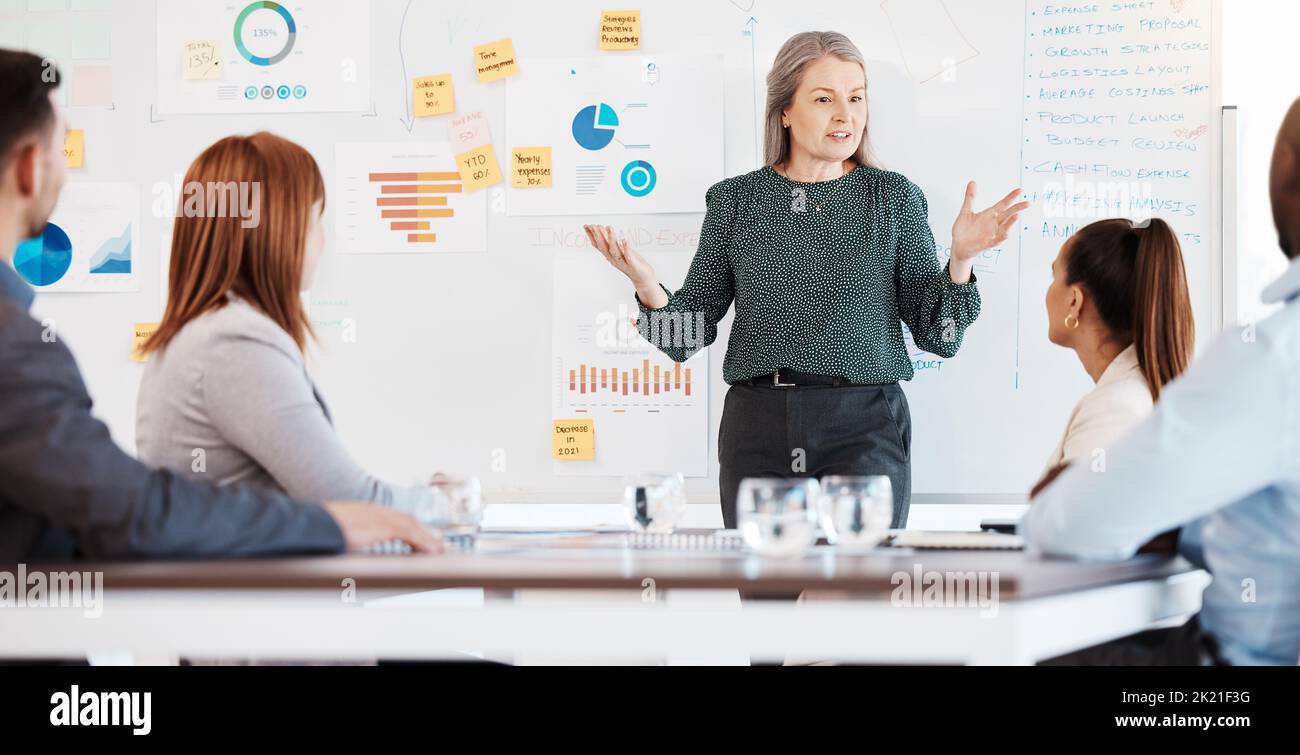 Manager doing a presentation in business meeting with financial charts ...