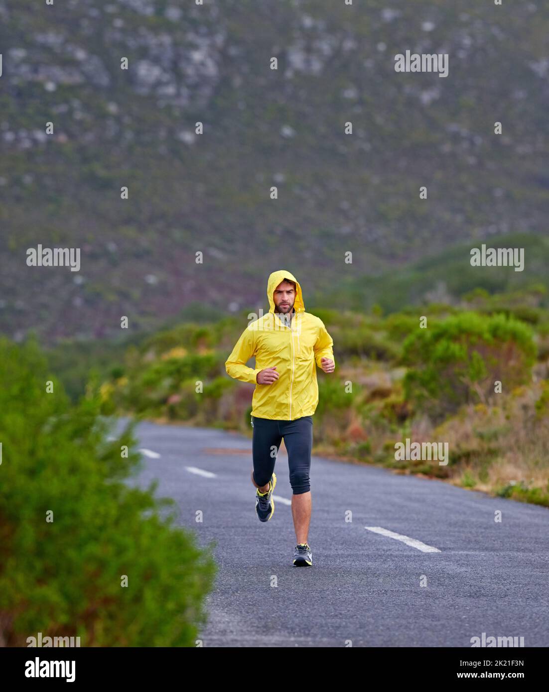 Getting in some weekend training. a handsome young man running with ...