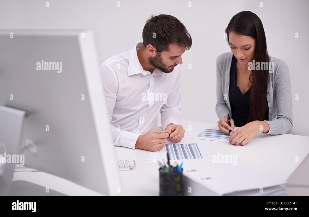 Getting the boss approval. two young business colleagues discussing ...