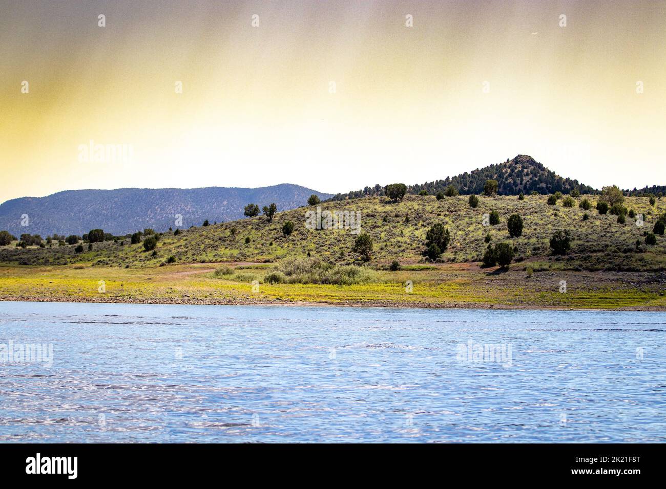 A scenic shot of a landscape with green mountains and a lake - great ...