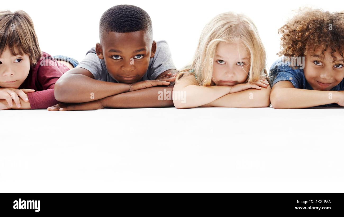 No adults allowed. Studio shot of a group of young friends lying on the ...