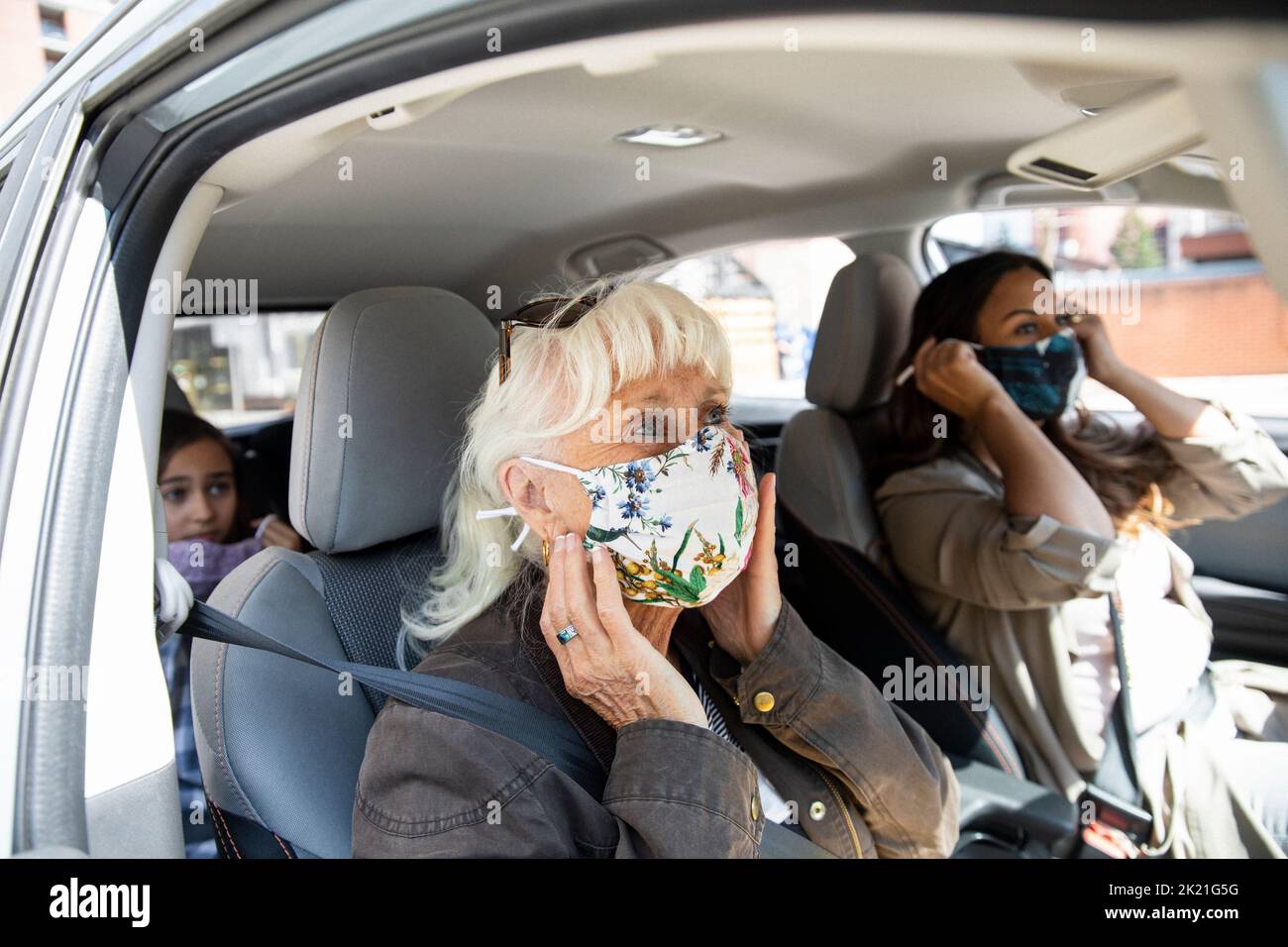 Putting on protective masks hi-res stock photography and images - Alamy