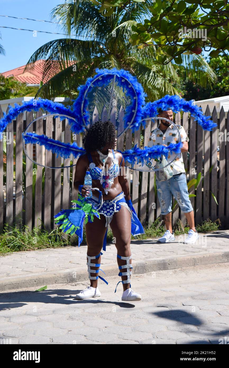 A young Belizean woman, in a blue costume, dancing and having fun in ...