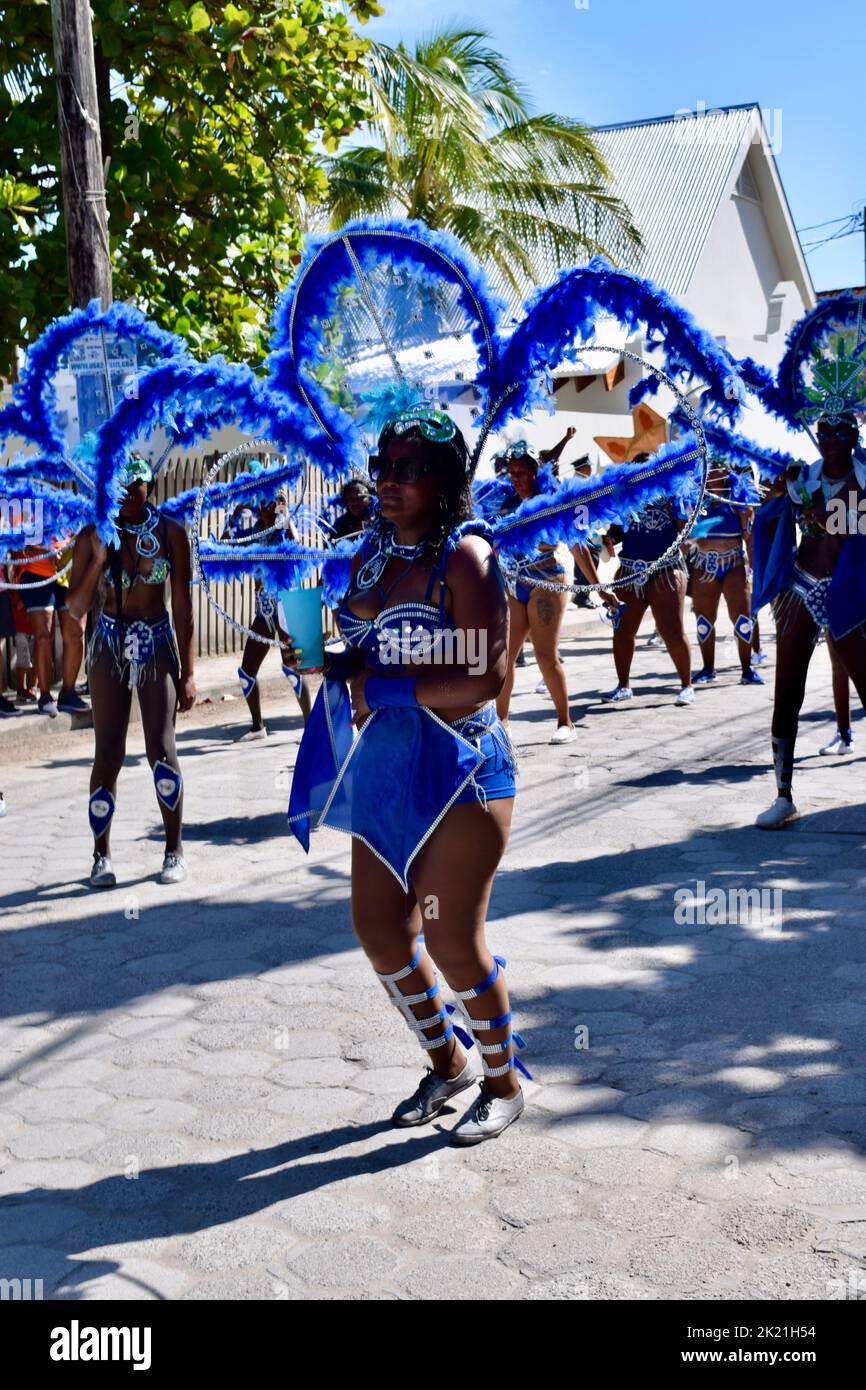 A young Belizean woman, in a blue costume, dancing and having fun in ...