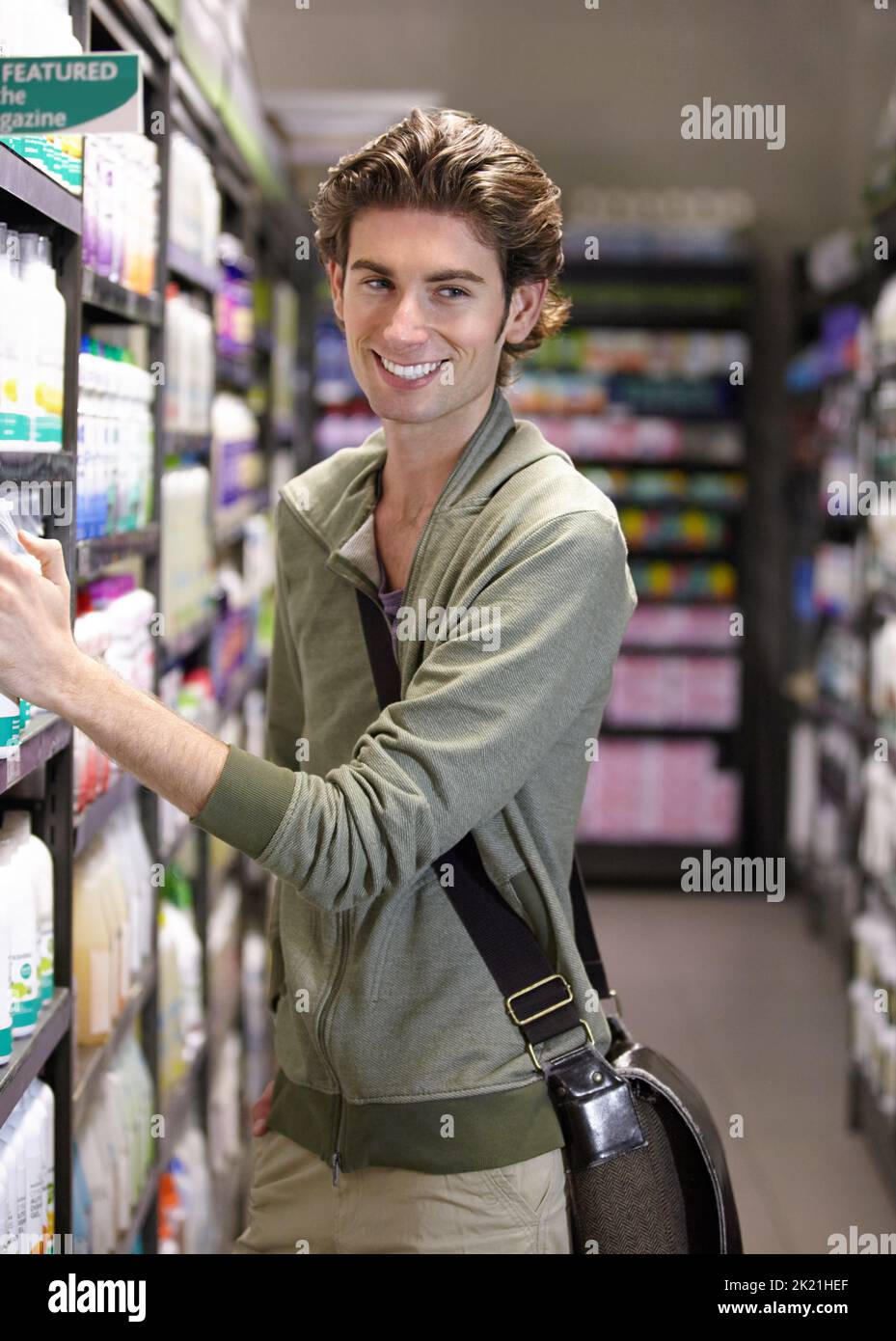 I like this product. A young man comparing the prices of some items ...