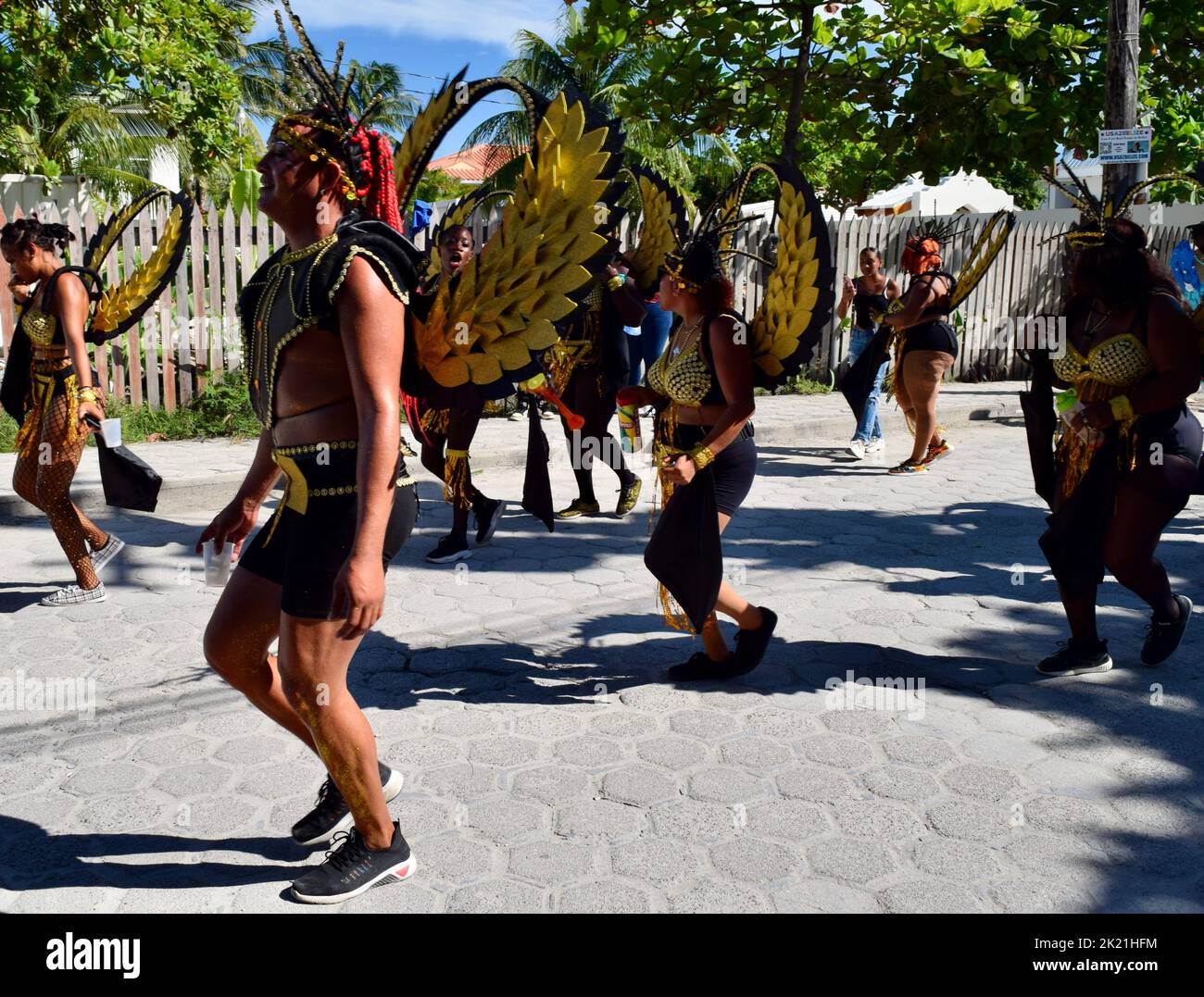 A Belizean man and women wearing shiny, winged, black and yellow ...