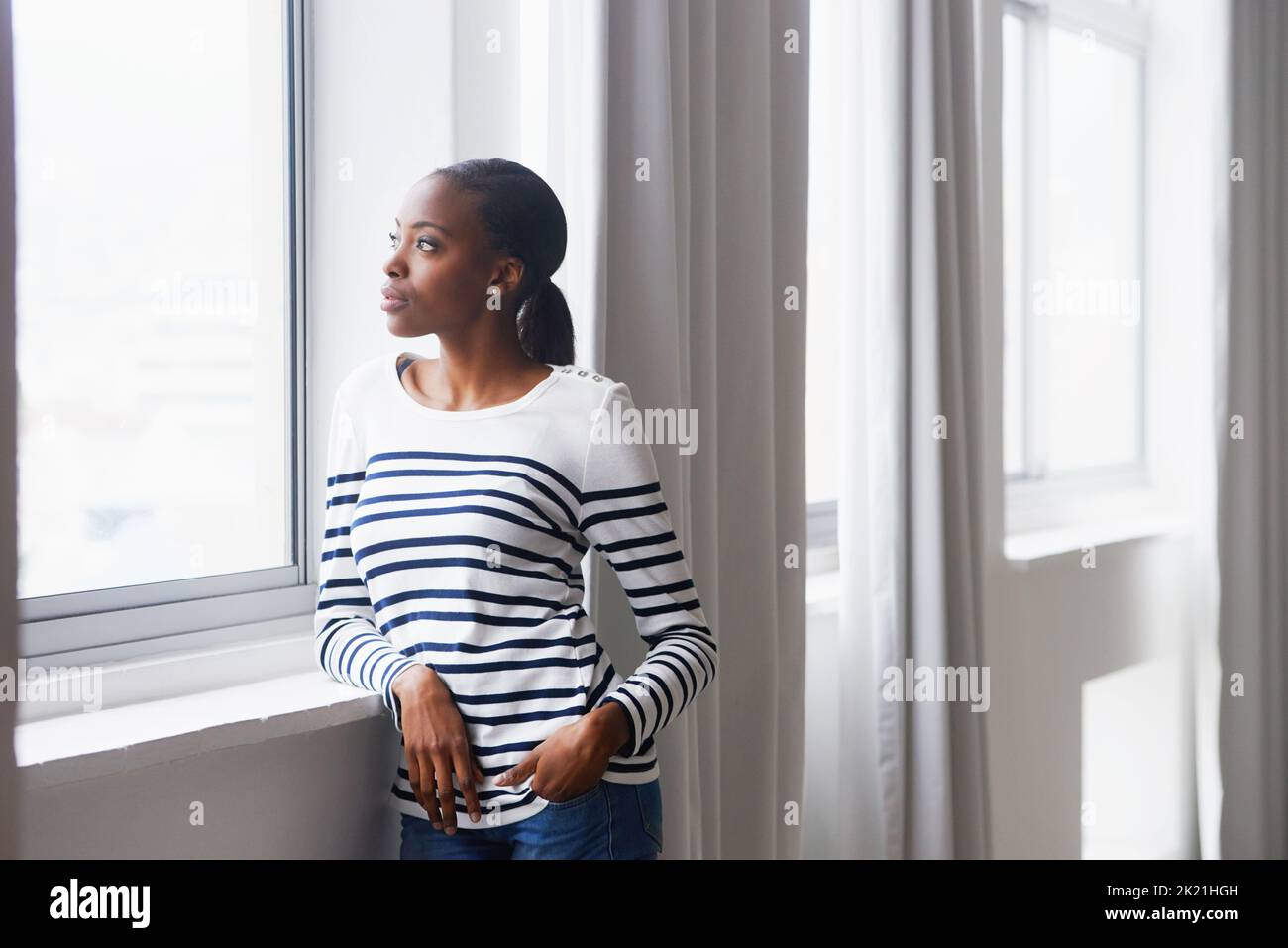 Wondering what to do with her day off. A beautiful young woman ...