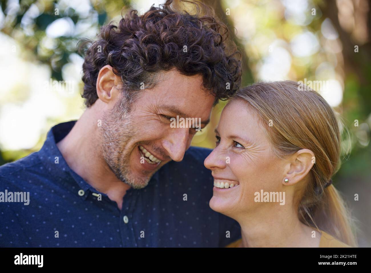 Their love grows with age. an affectionate husband and wife standing ...