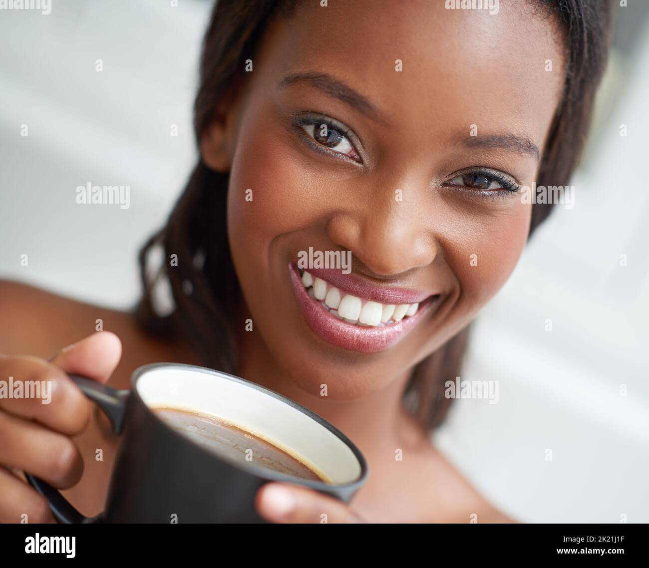 Kickstarting her morning. A young ethnic woman enjoying a cup of coffee ...