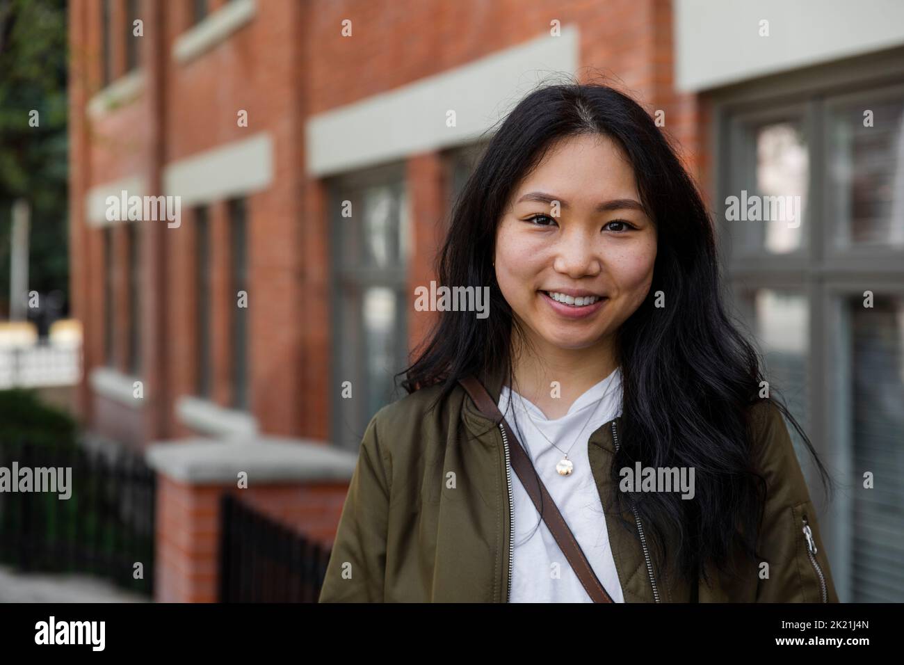 Young woman smiling outside hi-res stock photography and images - Alamy