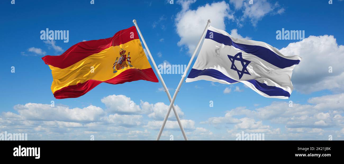 two crossed flags Israel and spain waving in wind at cloudy sky ...