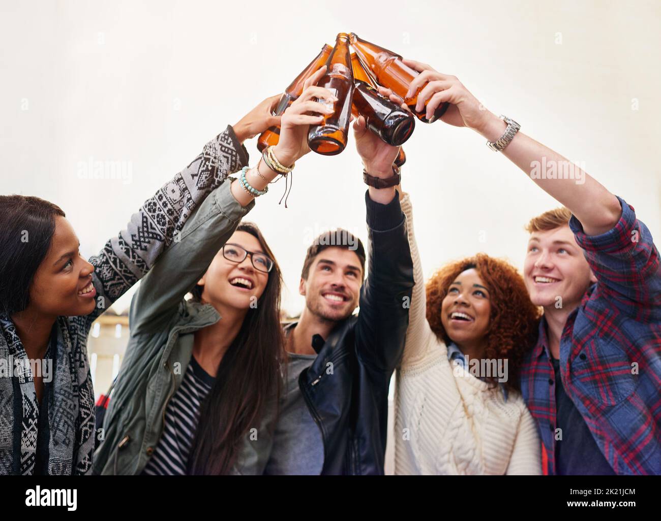 Cheers. a group of friends hanging out and drinking beers Stock Photo ...