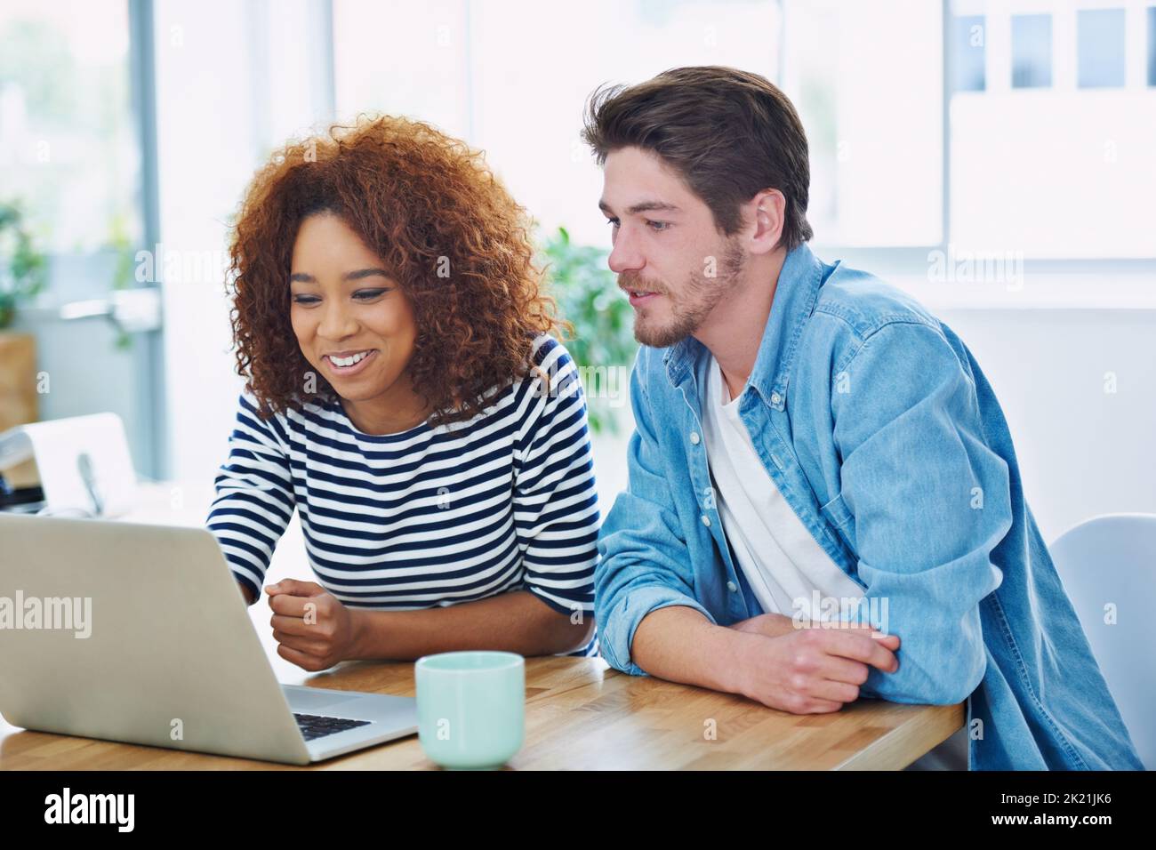 Together everyone achieves more. two coworkers working together at ...
