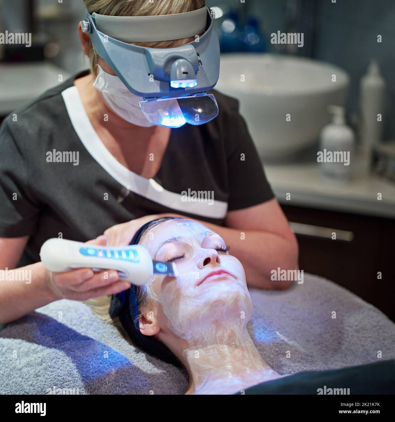 Taking back the years. a woman getting a non-invasive face lift at a ...