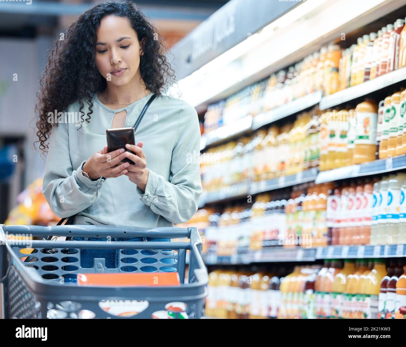 Supermarket, phone and woman shopping, search and on internet for ...
