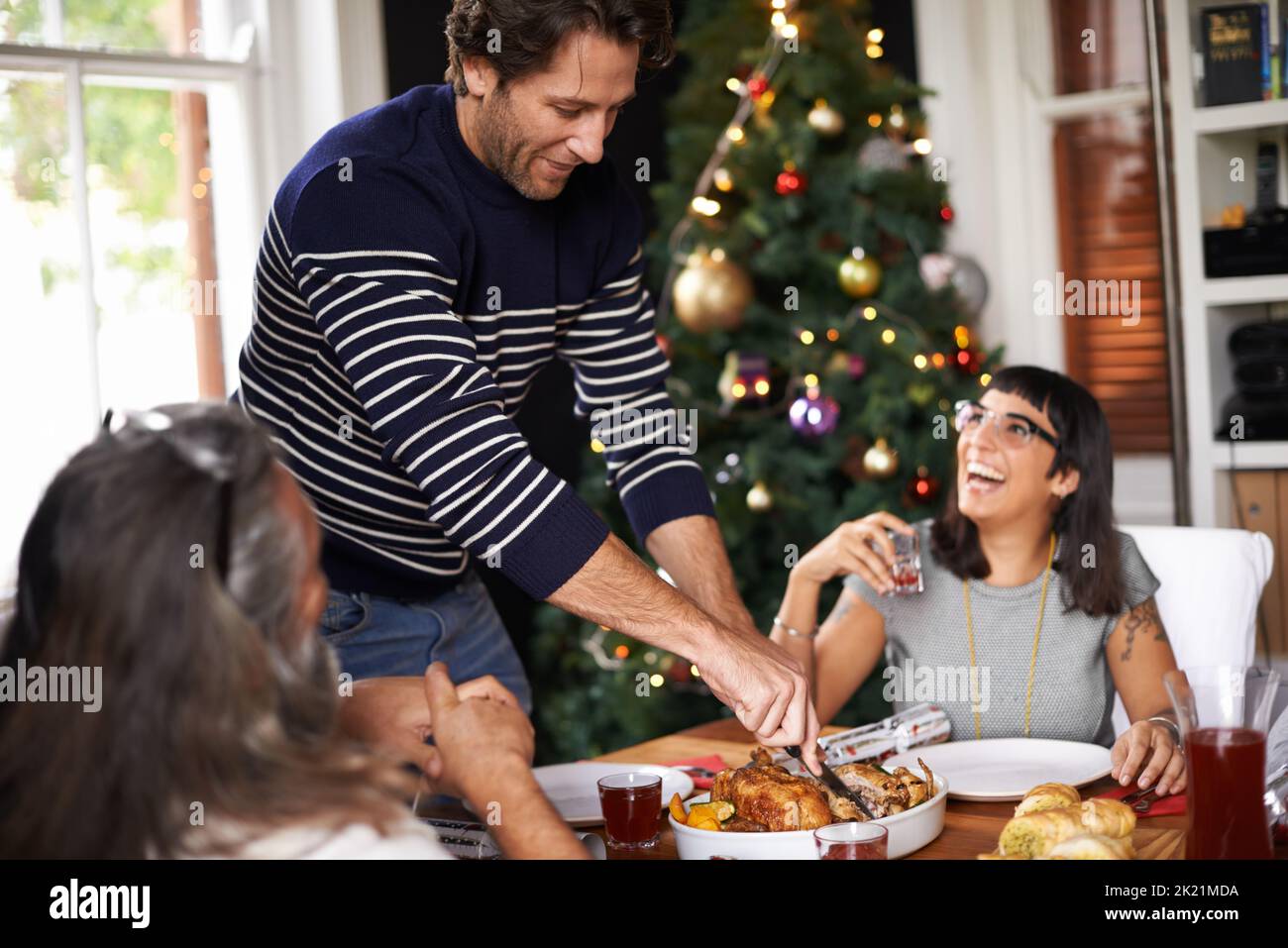 Carve faster - were hungry. a man carving a chicken on Christmas Stock ...
