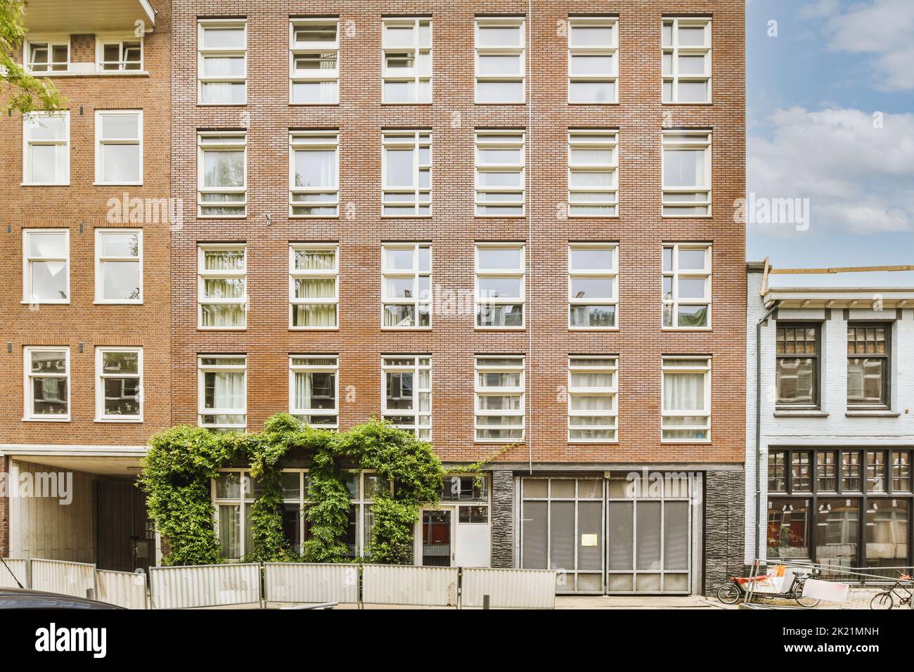 Panorama view of brick houses from an empty sidewalk stre trees and ...