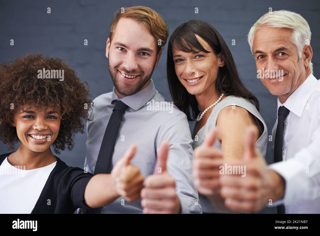 You can do it. Portrait of a group of professional coworkers giving ...