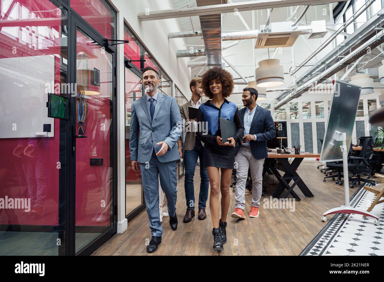 Group of multiethnic business people crossing office together Stock ...