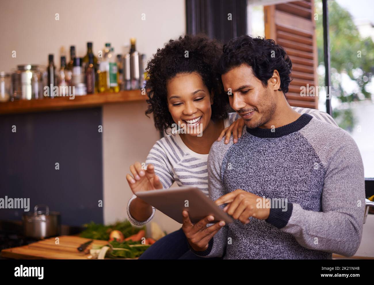 Lets try out this recipe for dinner. a young couple using their tablet ...