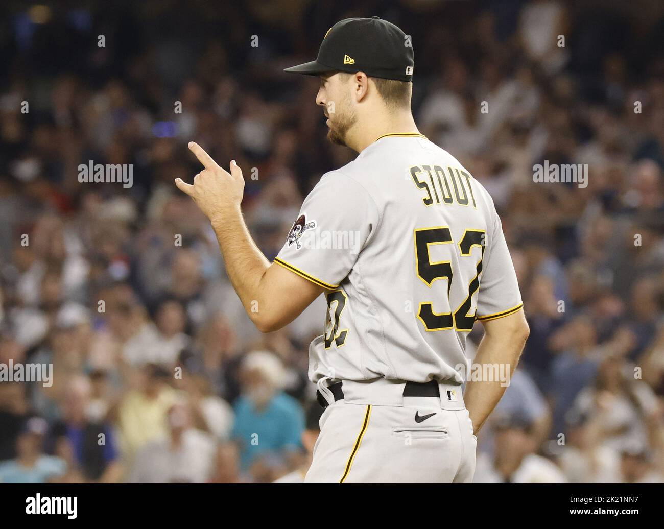 Pittsburgh Pirates pitcher Eric Stout gestures after walking New York ...