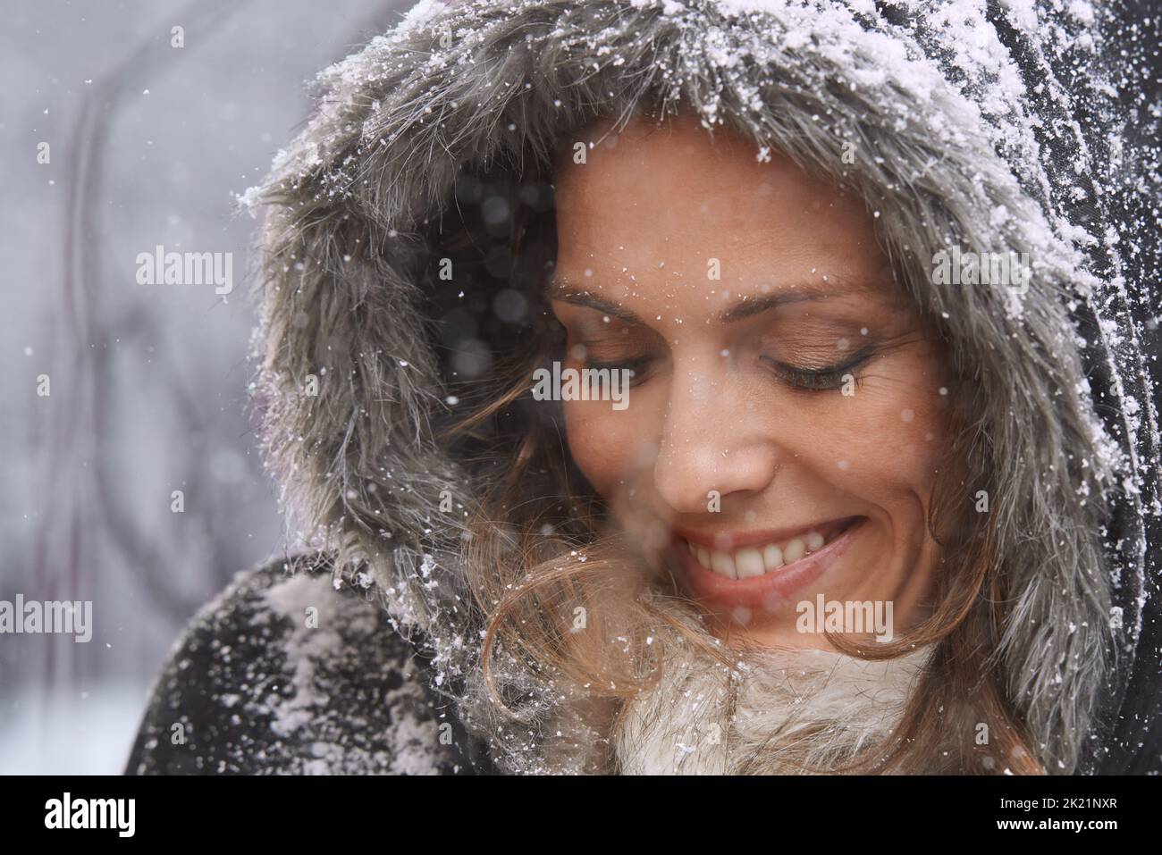 Loving the first snowfall. an attractive woman enjoying herself outside ...