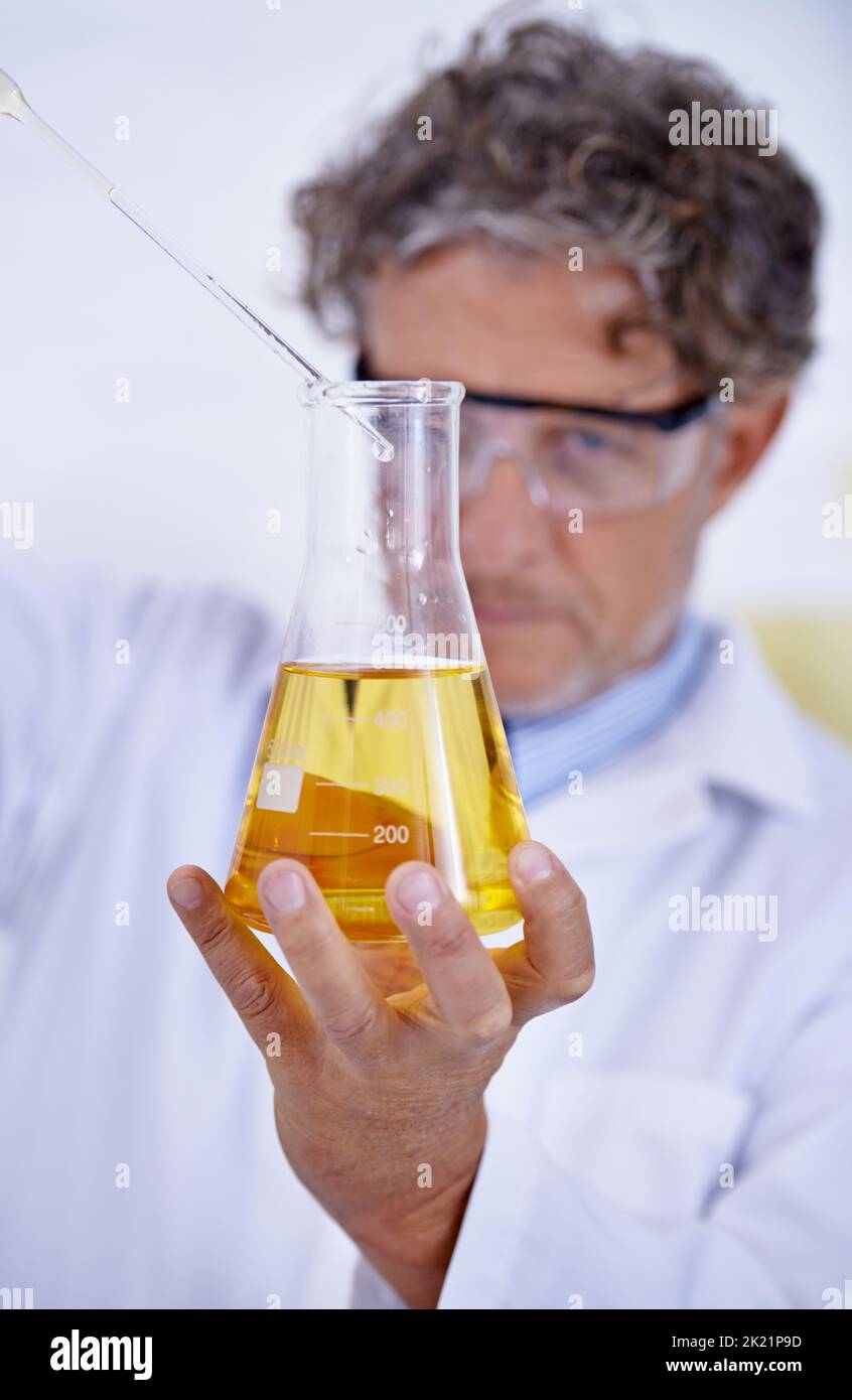 Working with absolute precision. A cropped shot of a mature scientist ...