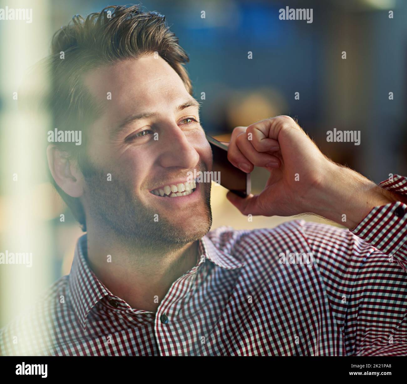 Awesome. a handsome businessman talking on his mobile phone in the ...