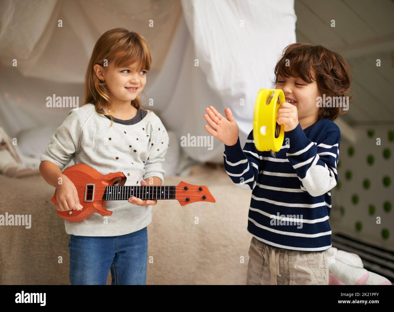 Baby band. two adorable siblings playing with their musical toys Stock ...