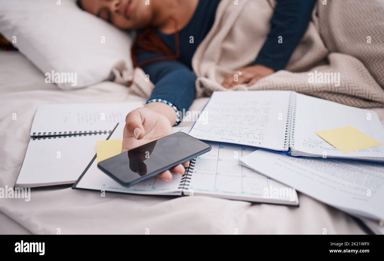 Phone, books and sleeping woman student tired from learning, studying ...