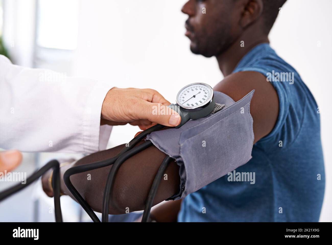 Hes in for a routine checkup. a doctor taking a male patients blood ...