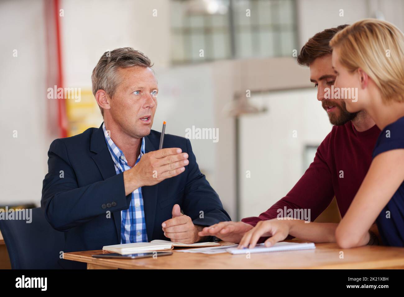 Giving them professional advice on asset management. Young couple ...