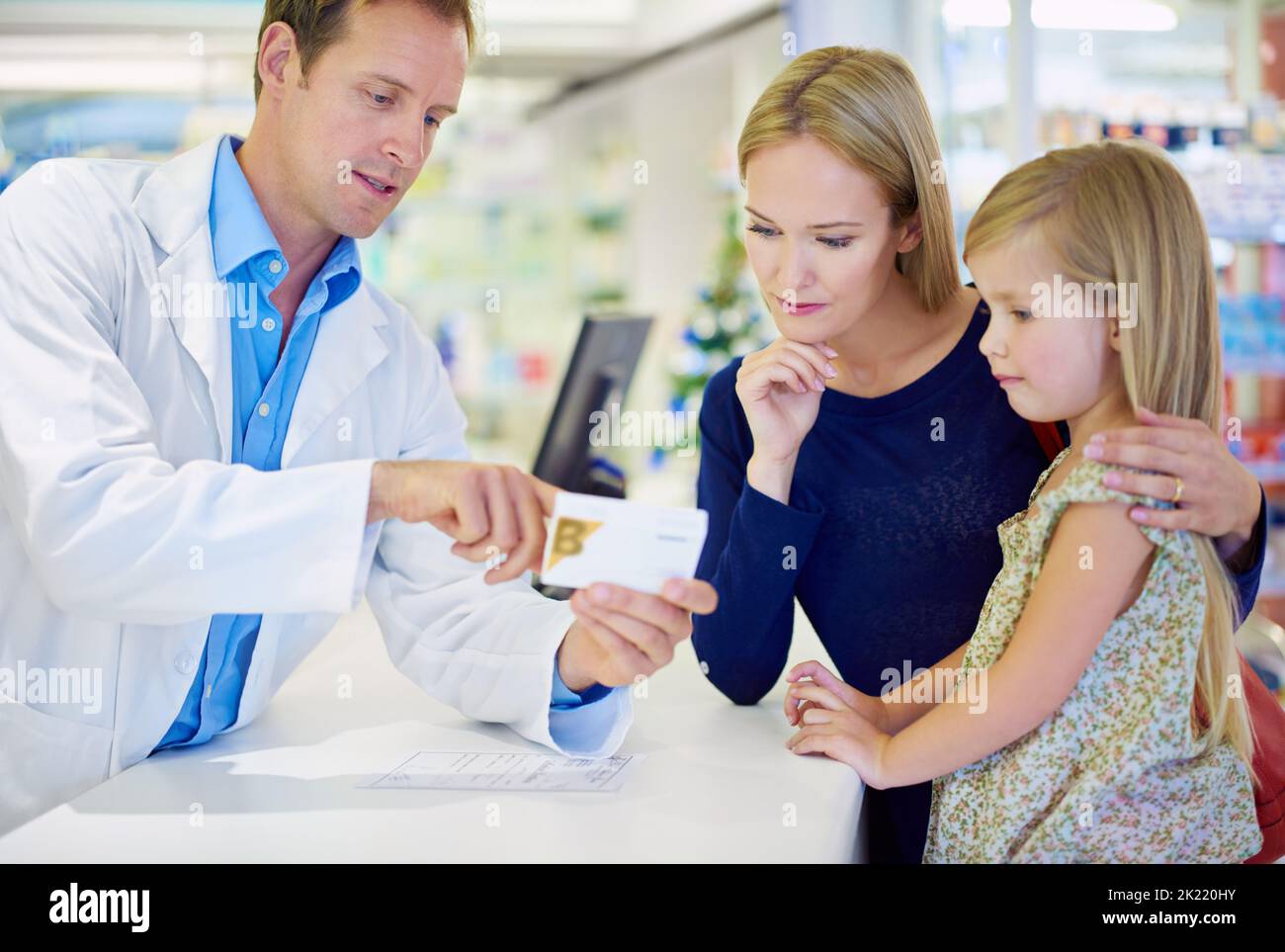 This is the proper dosage here. A pharmacist giving medication to a ...