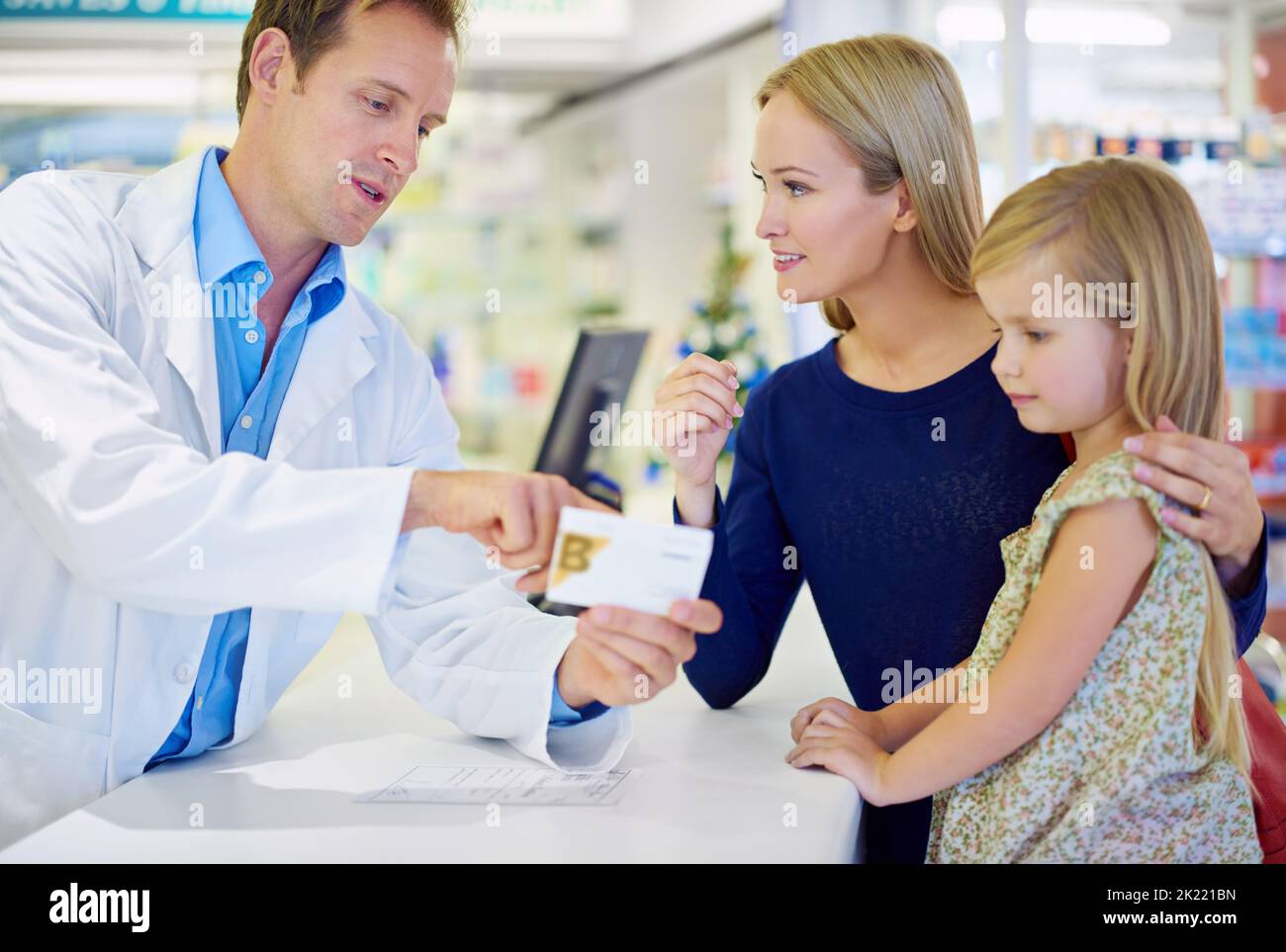 Its perfect for children her age. A pharmacist giving medication to a ...