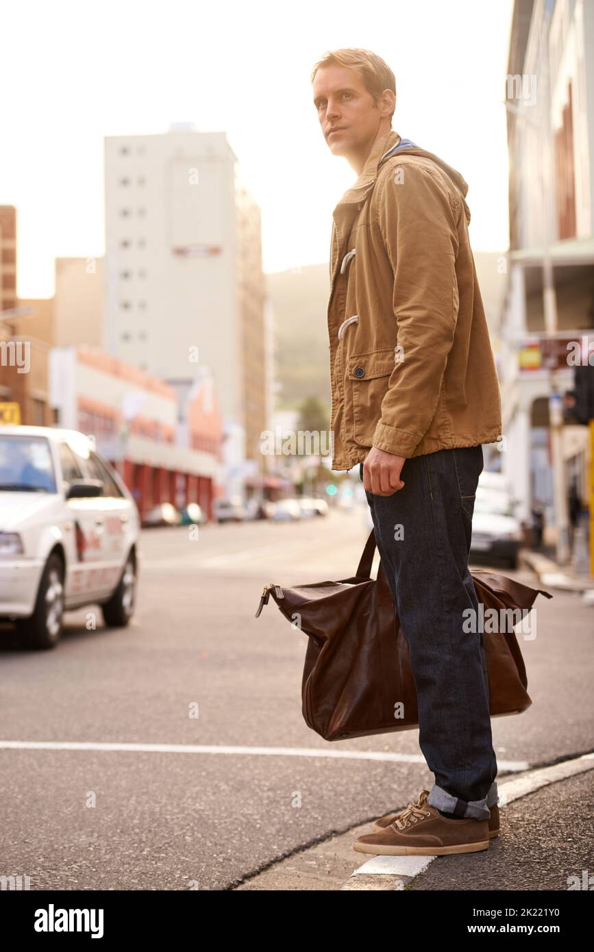 Always on the move. Full length shot of a fashionable man waiting to ...