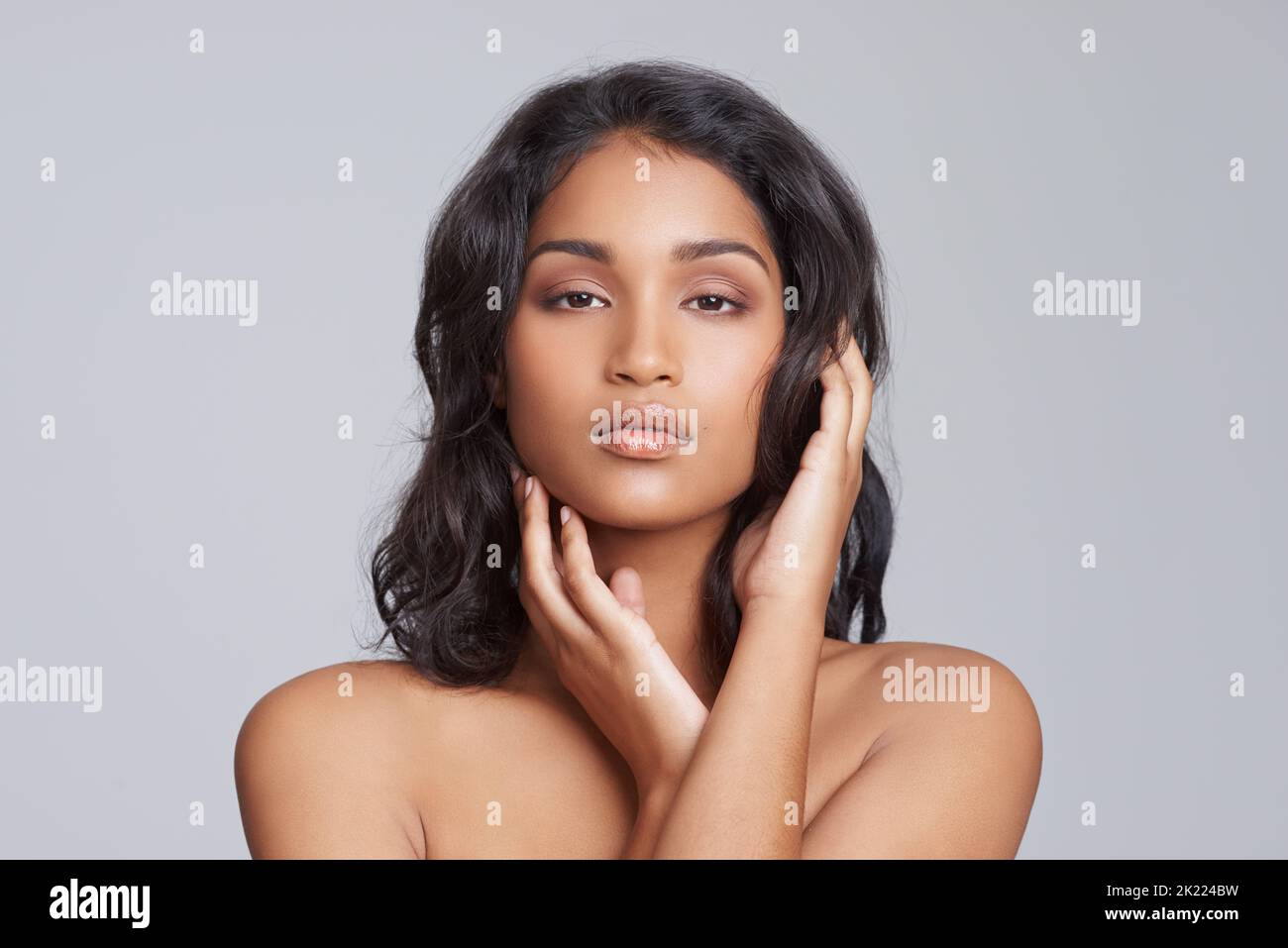 All natural beauty. a beautiful young posing over a gray background ...