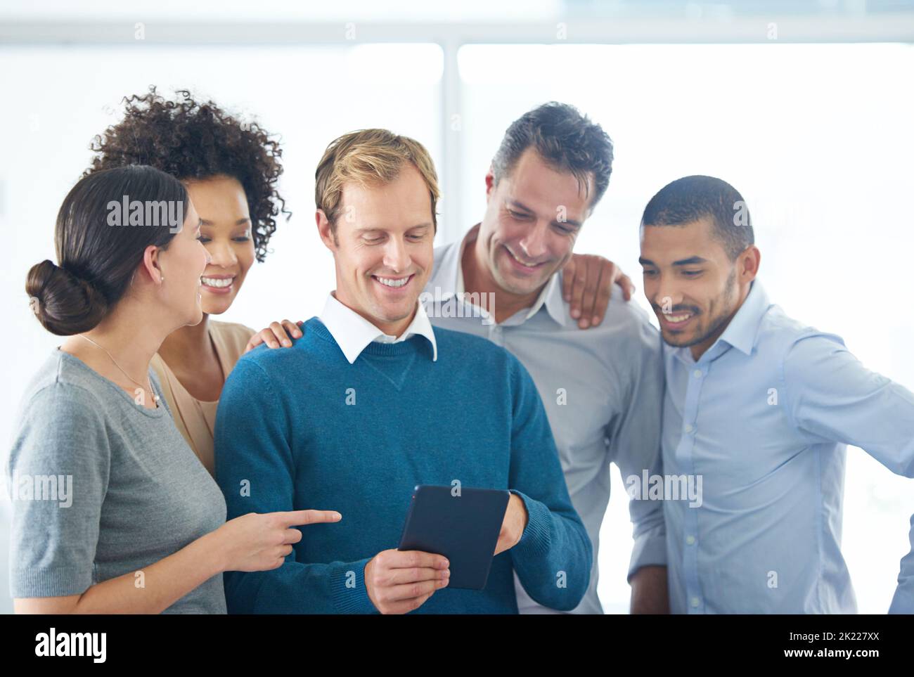 We can do so much with technology. a group of colleagues using a digital tablet together Stock ...
