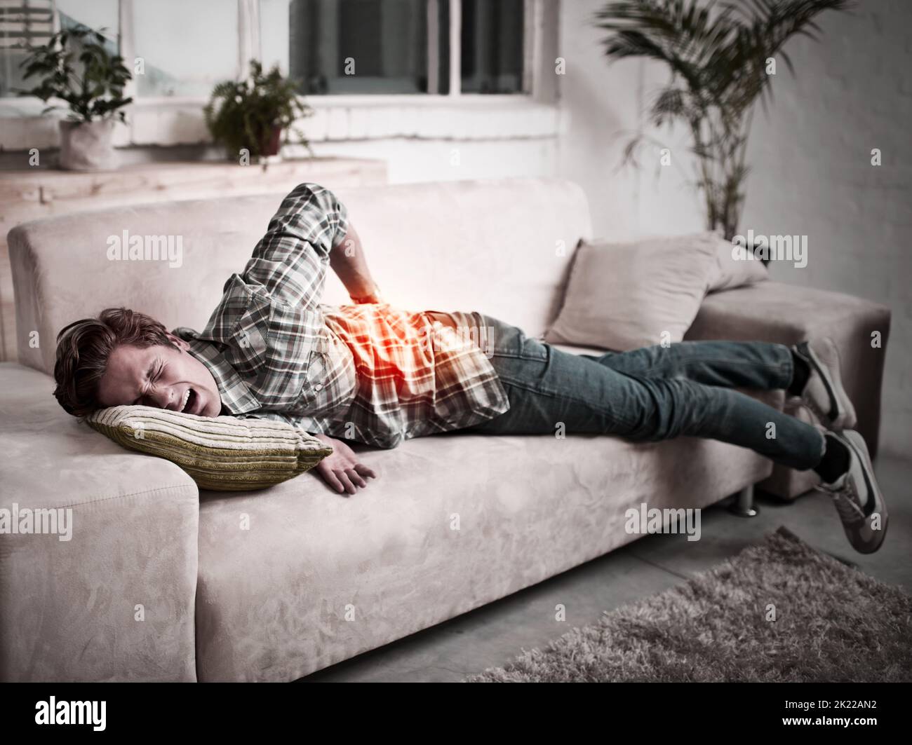 I shouldnt have lifted all those heavy things...A young man lying on ...