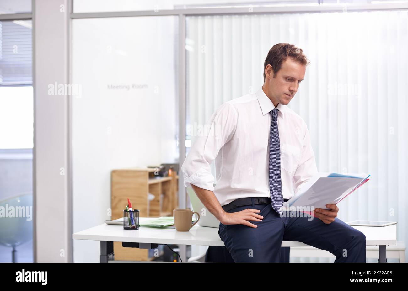 Young man focusing on documents hi-res stock photography and images - Alamy