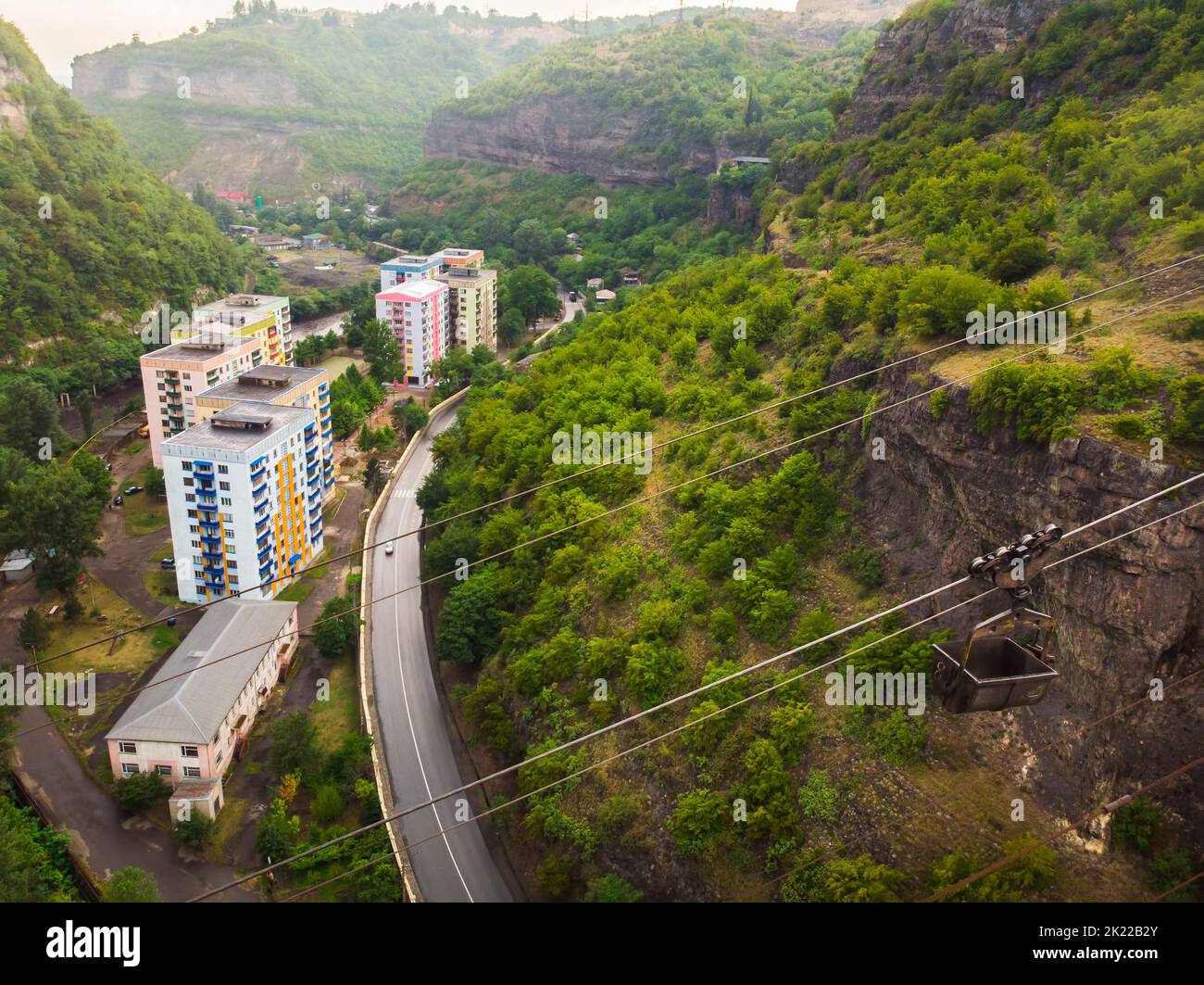 Aerial view rope way with metal buckets with load above road in Mining ...