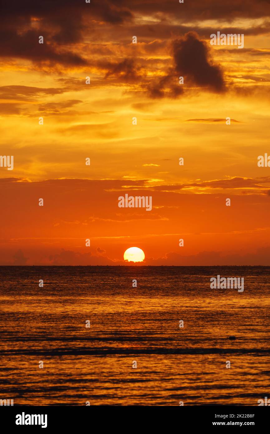 Vivid sunset from Cozumel with setting sun nestled into clouds on the ...