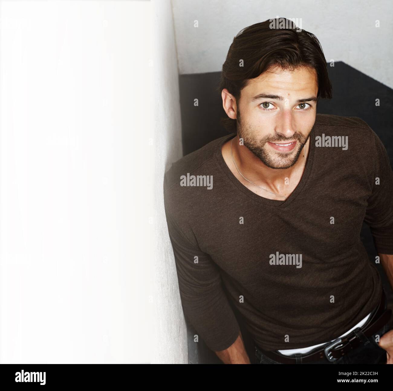 Rustic and rugged. Portrait of a handsome young man leaning against a ...