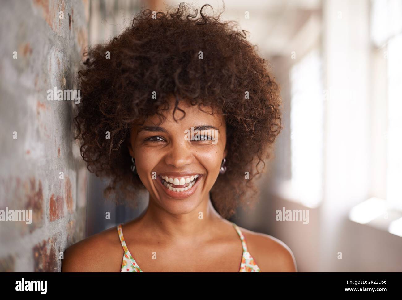 Happy smiles. Cropped portrait of an attractive young woman leaning ...